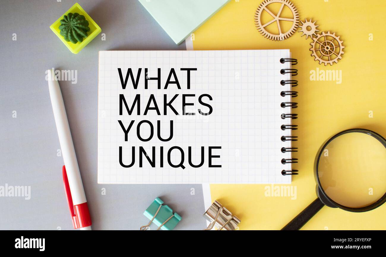 What makes you unique text and alarm clock on white brick wall and ...