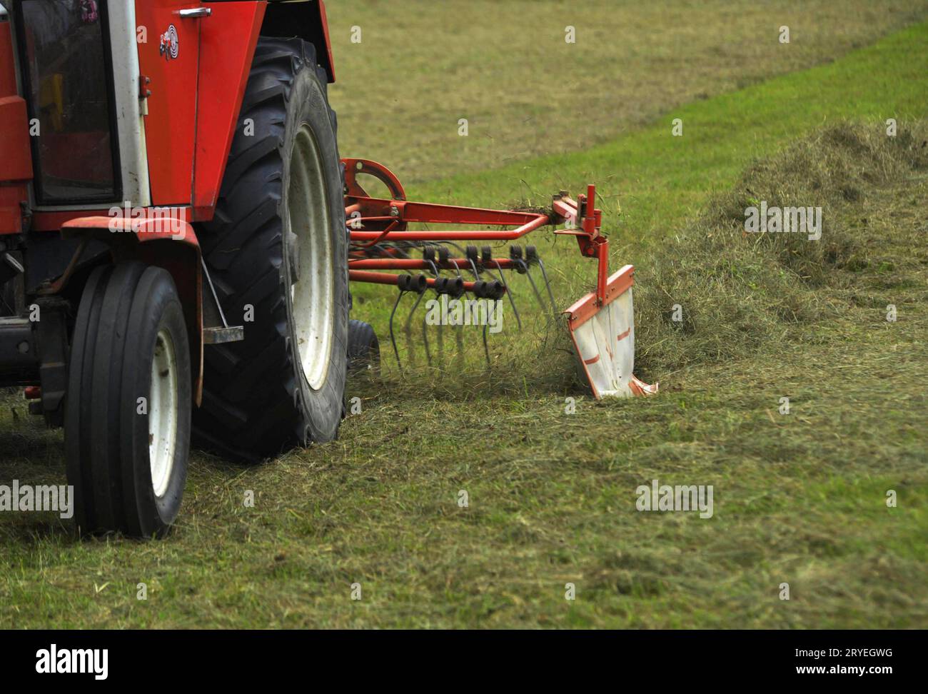 Hay turning machine in agriculture Stock Photo - Alamy