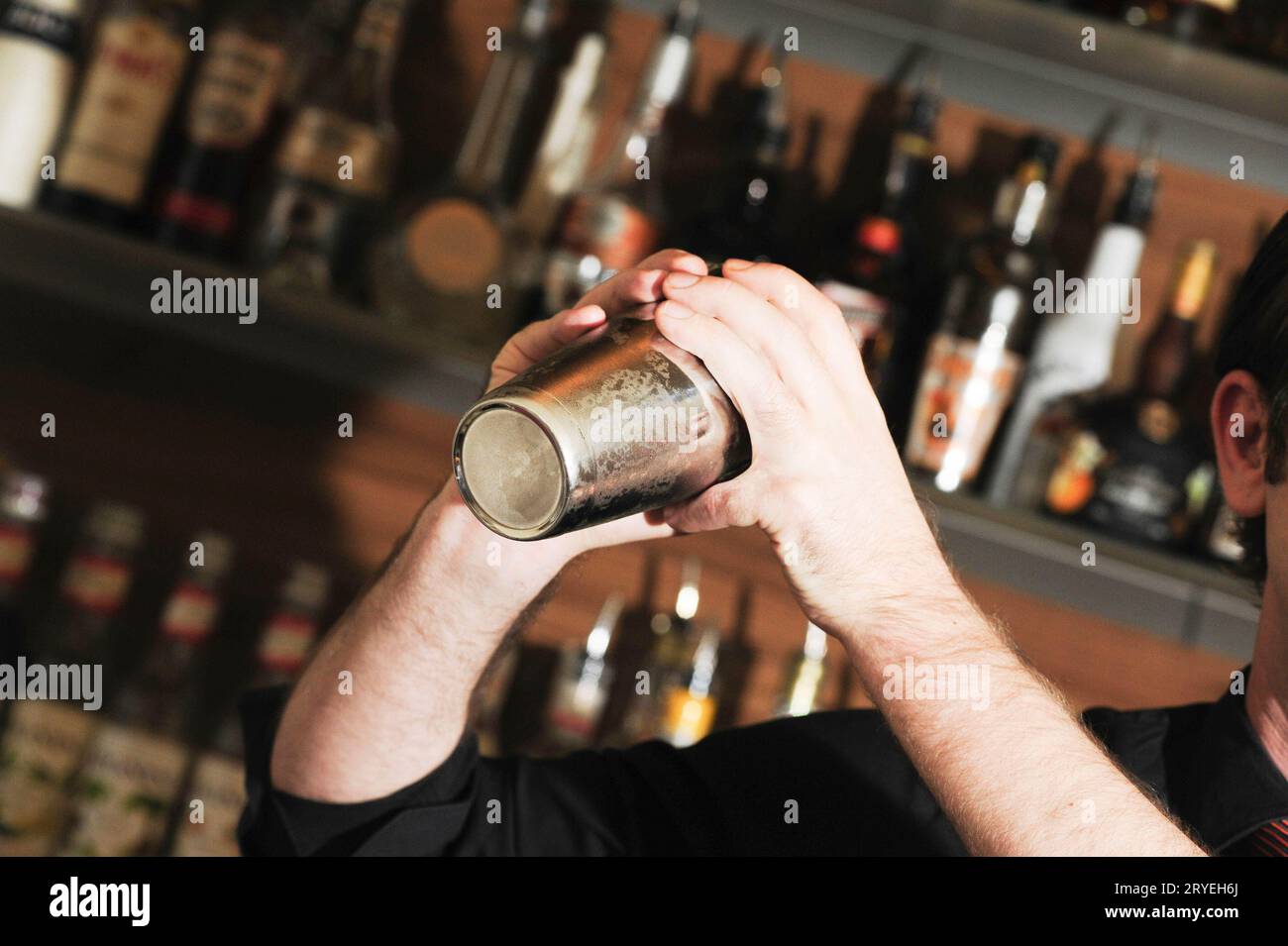 Barkeeper mixing drinks together in a bar Stock Photo - Alamy