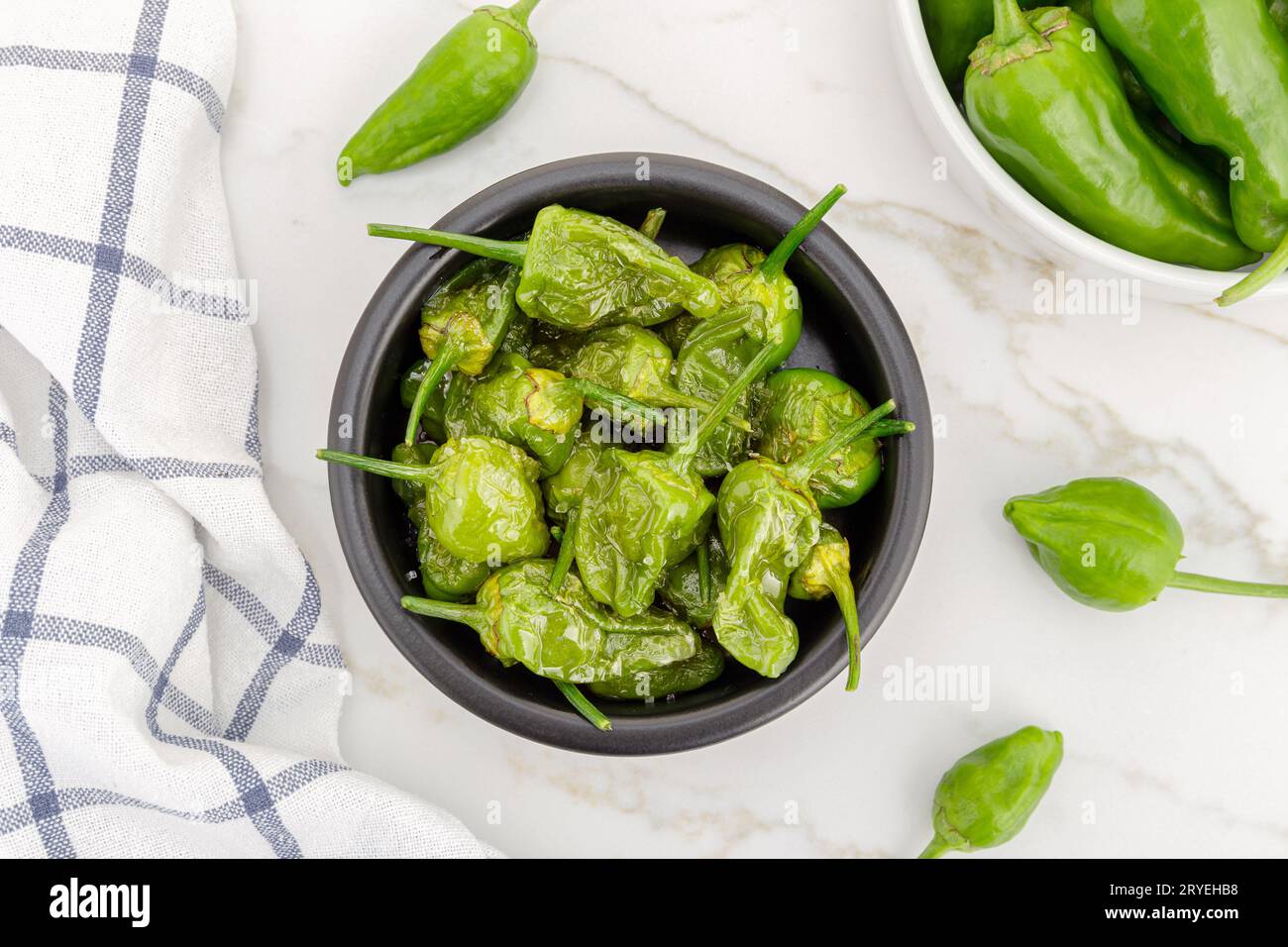 Top view of Cooked Padron peppers in a a bowl on marble table Stock ...