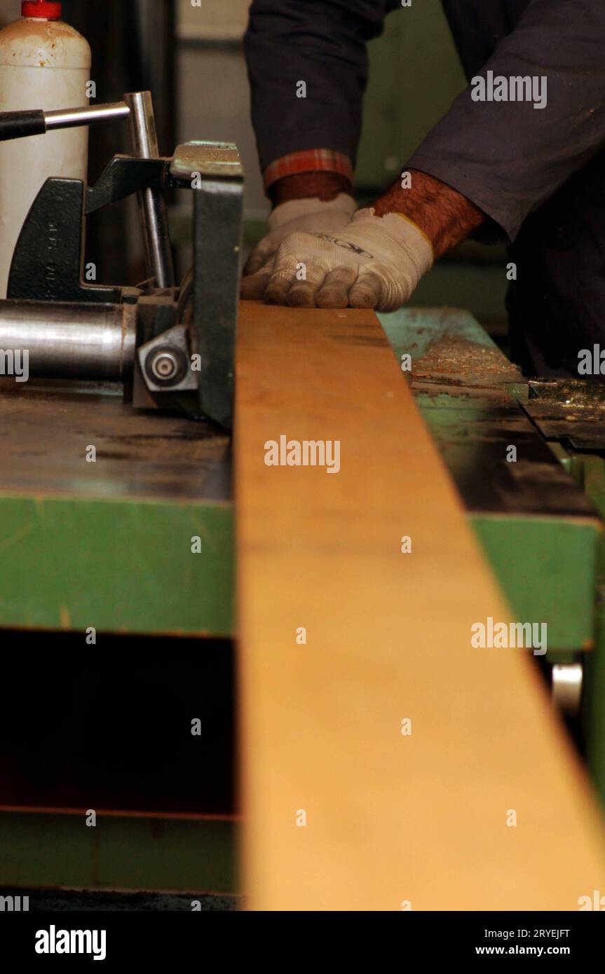 Carpenter planing a piece of wood Stock Photo - Alamy