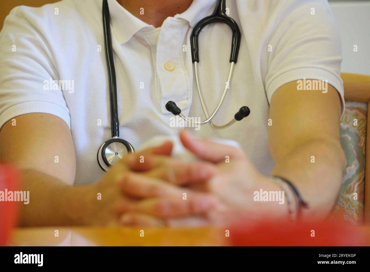 Doctor wearing a stethoscope around his neck Stock Photo - Alamy
