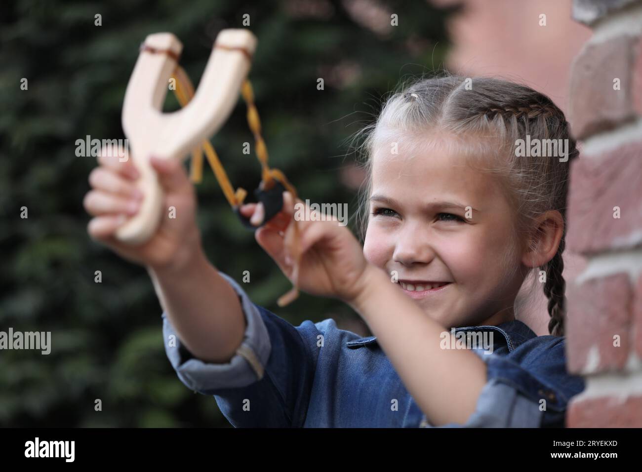 Little girl playing with slingshot outdoors. Kid's toy Stock Photo - Alamy