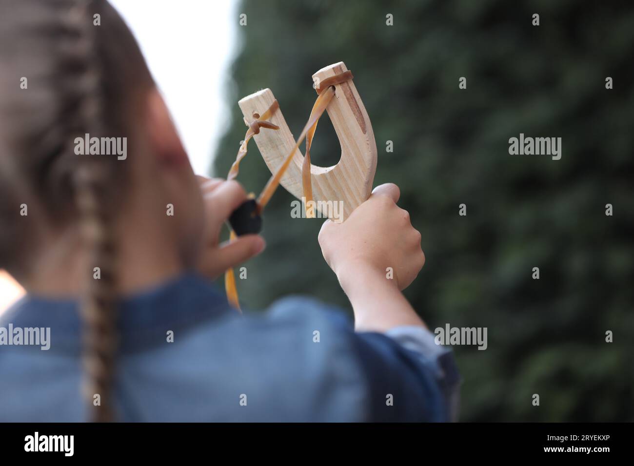 Little girl playing with slingshot outdoors, closeup Stock Photo - Alamy