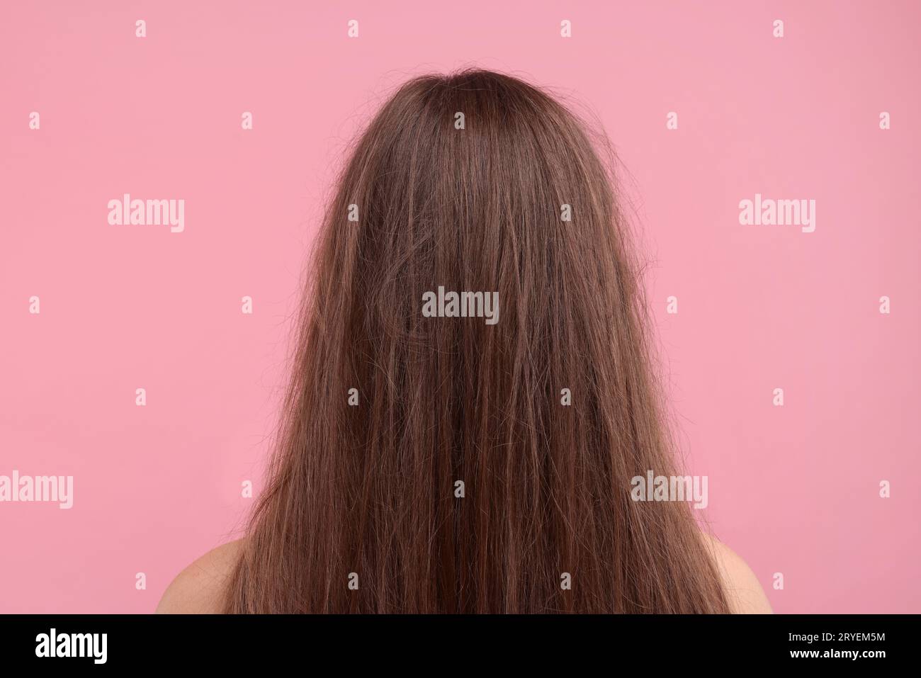 Woman with damaged messy hair on pink background, back view Stock Photo ...