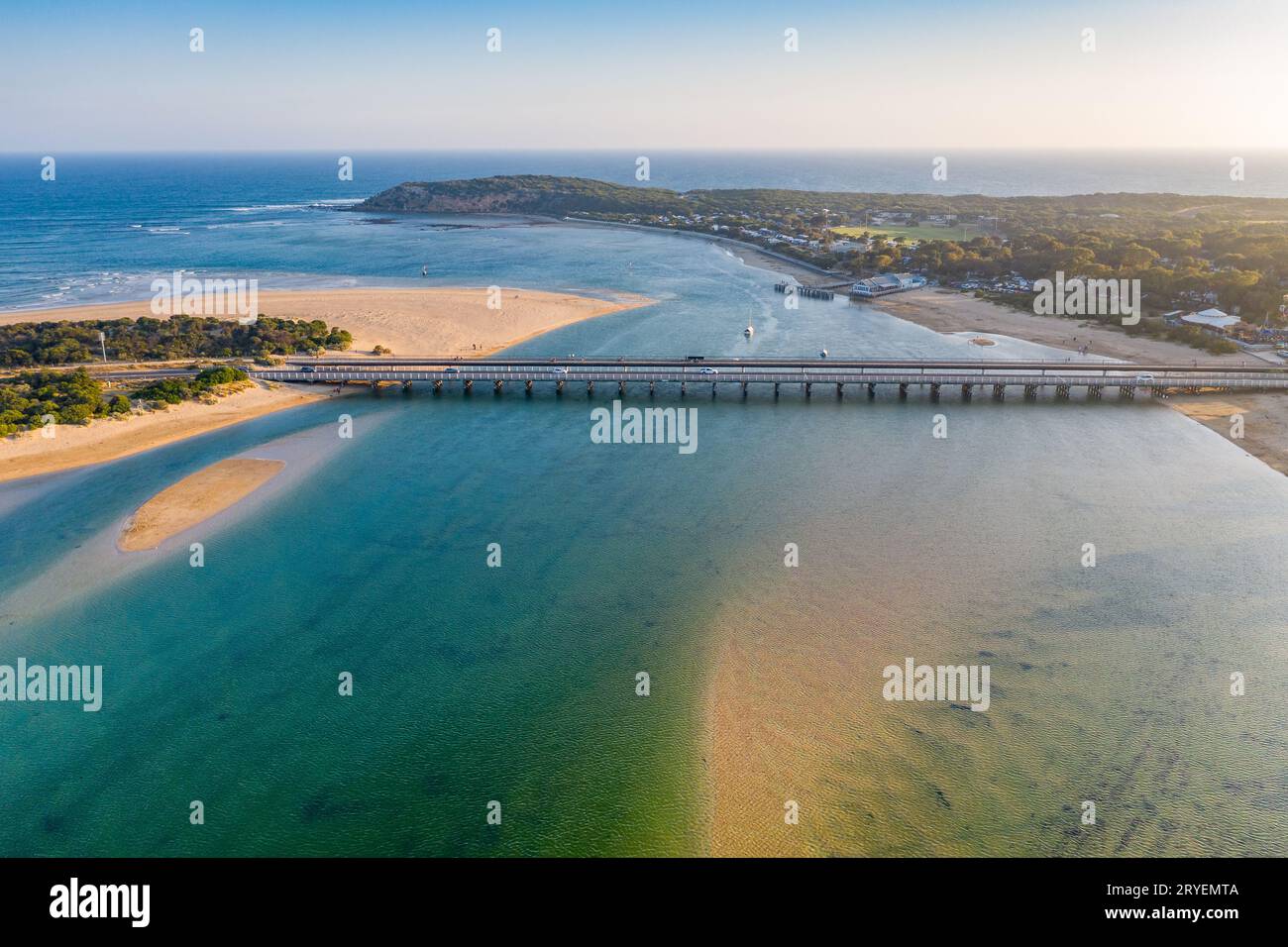 Aerial view of twin bridges over a wide coastal river with beaches on ...