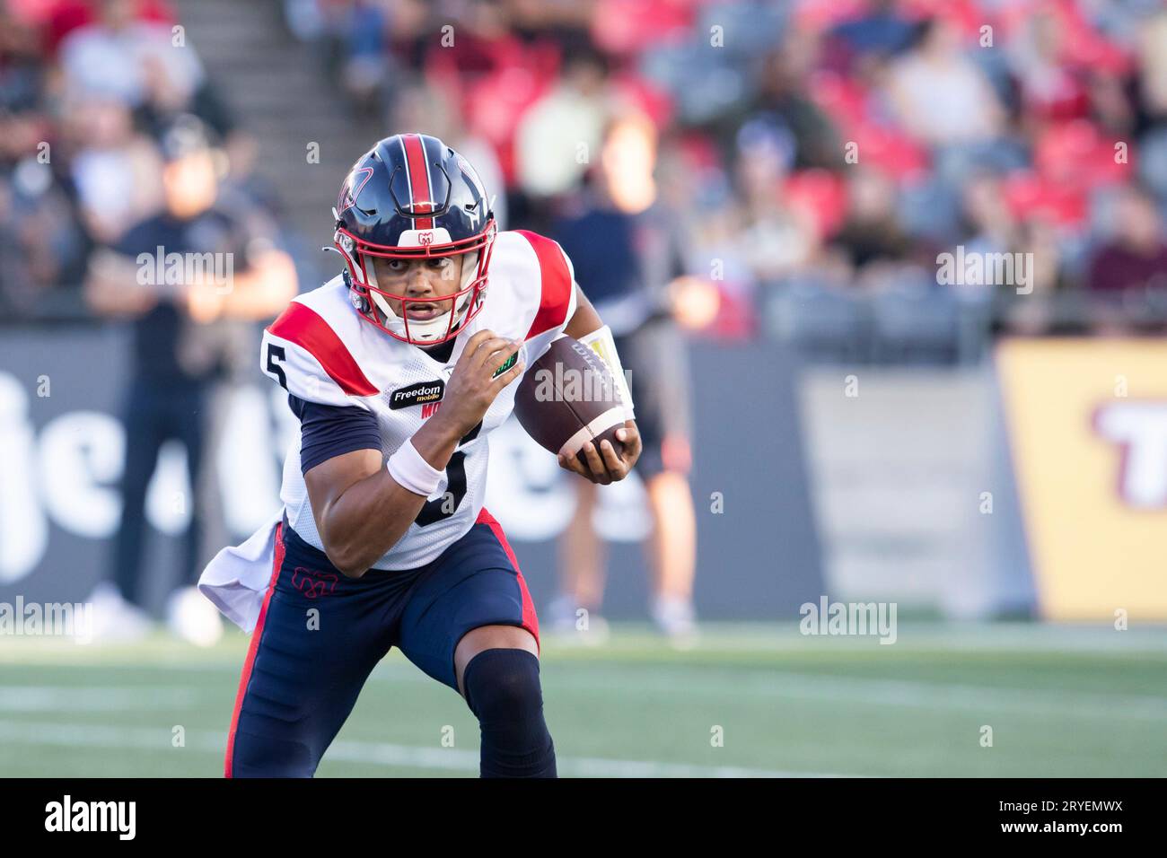 September 30, 2023: Montreal Alouettes quarterback Caleb Evans (5) runs ...