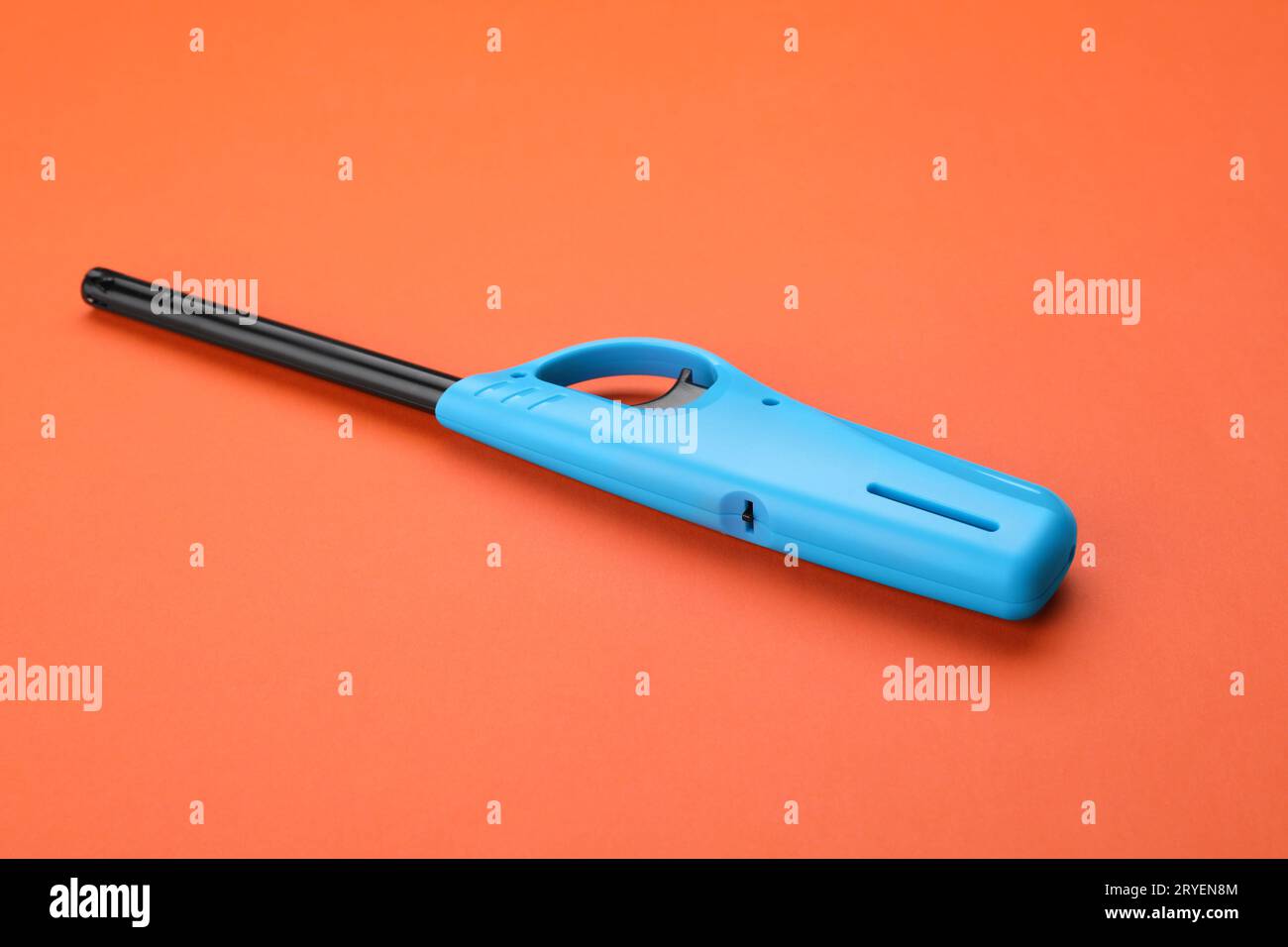 One blue gas lighter on orange background Stock Photo - Alamy