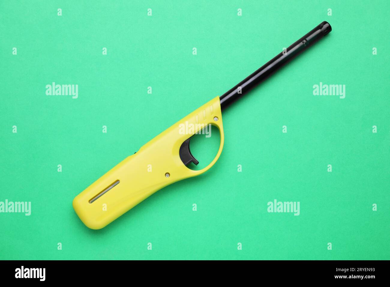 One gas lighter on green background, top view Stock Photo - Alamy