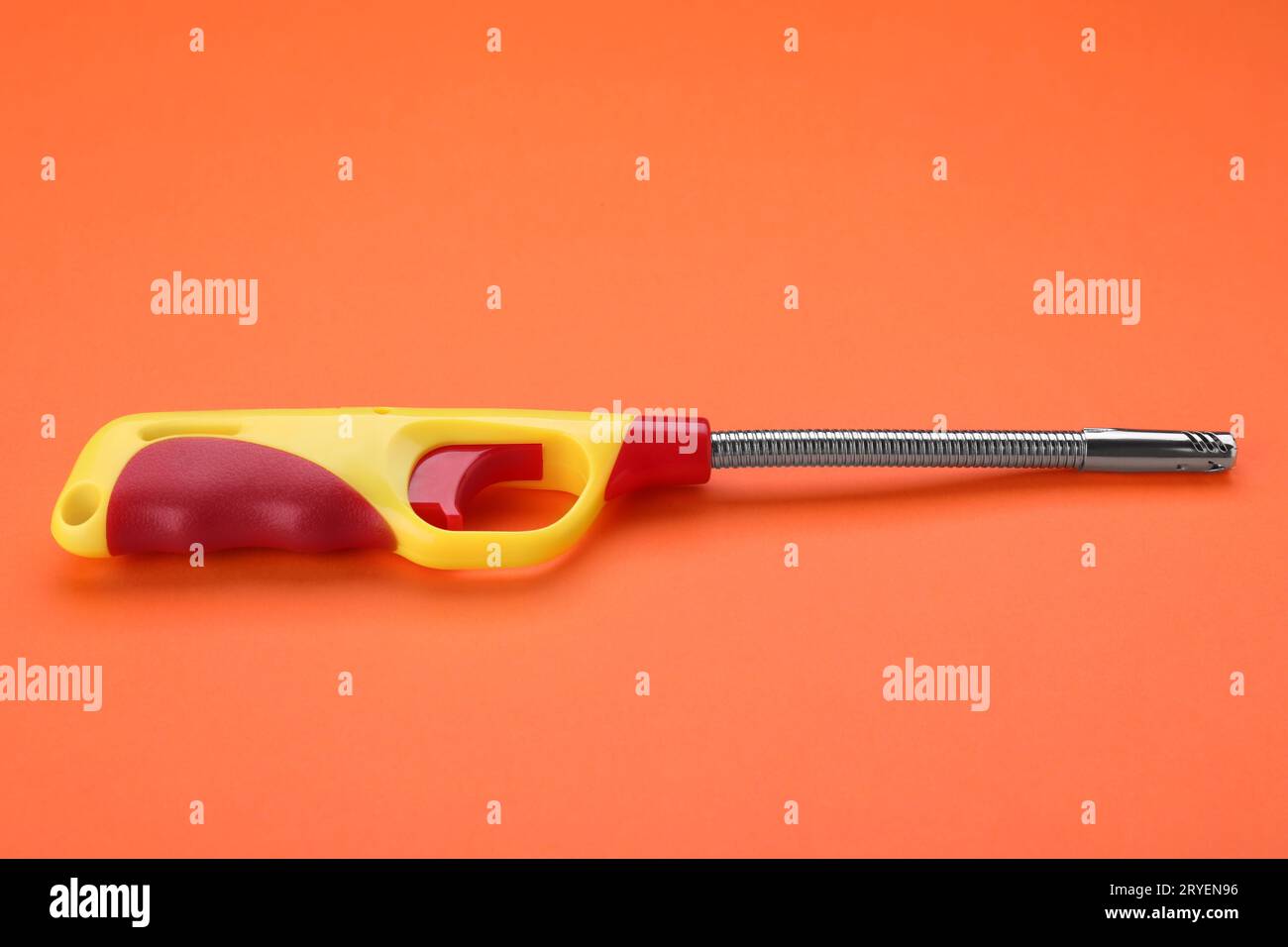 One bright gas lighter on orange background Stock Photo - Alamy