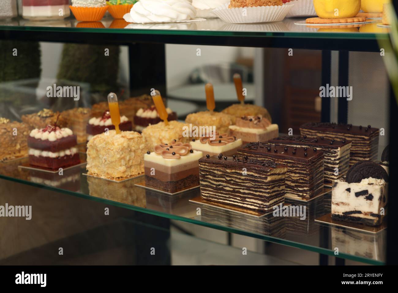 Different delicious desserts on counter in store Stock Photo - Alamy