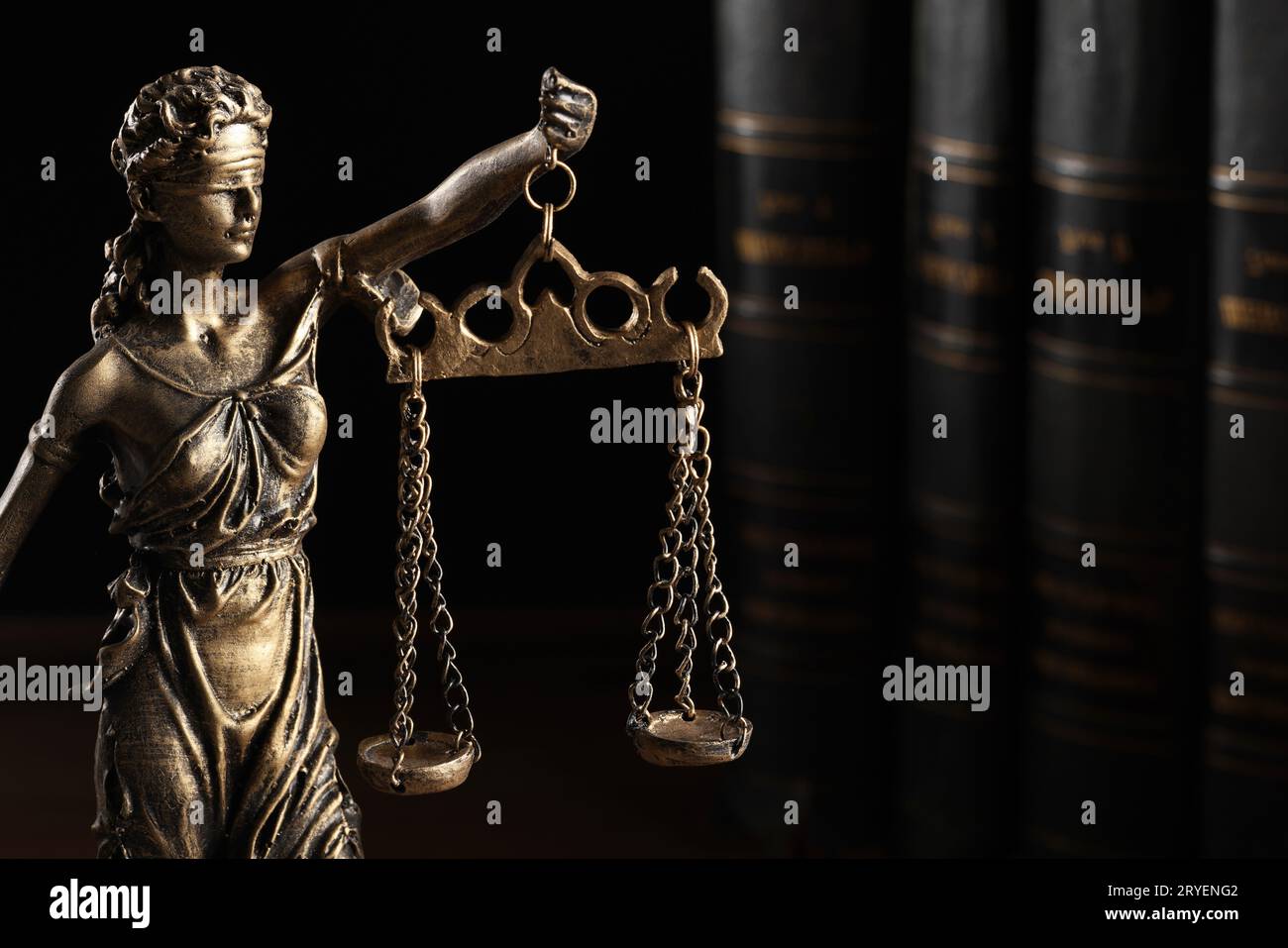 Symbol of fair treatment under law. Statue of Lady Justice and books on ...