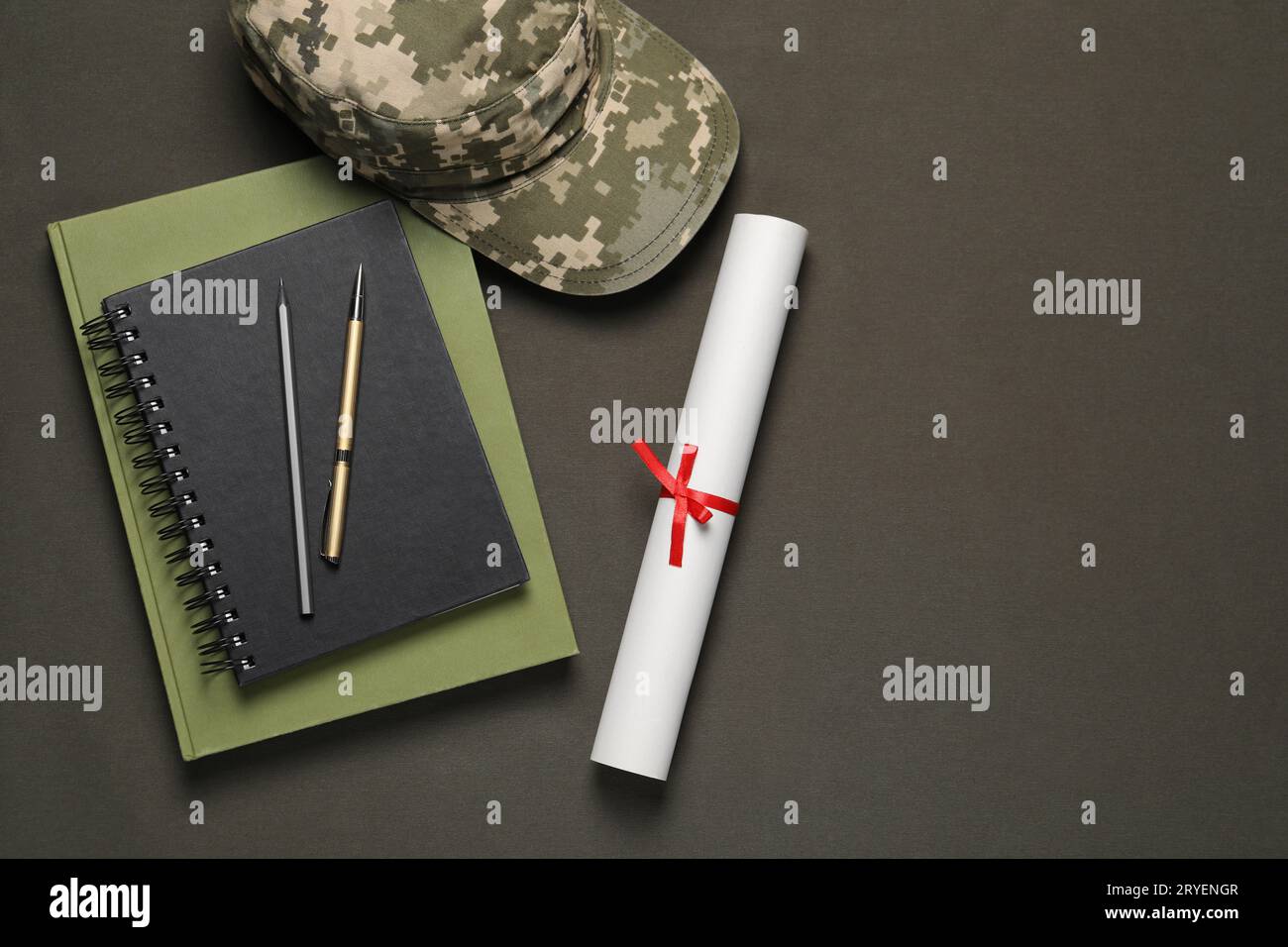 Stationery, soldier cap and diploma on dark background, flat lay with ...