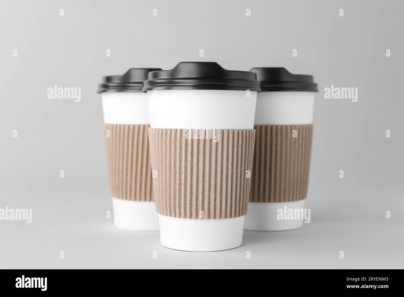 Paper cups with black lids on light grey background. Coffee to go Stock ...