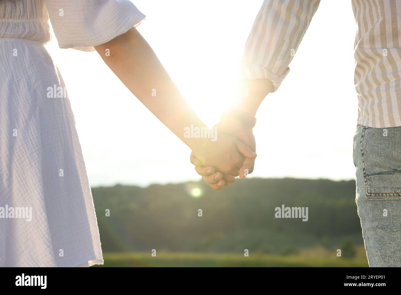 Romantic date. Couple holding hands outdoors, closeup Stock Photo - Alamy