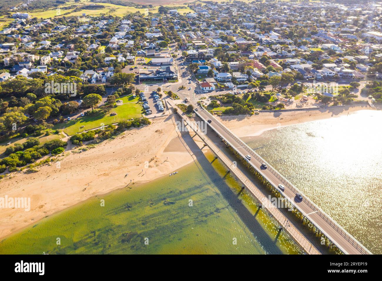 Aerial view of twin bridges crossing a wide river and entering a ...