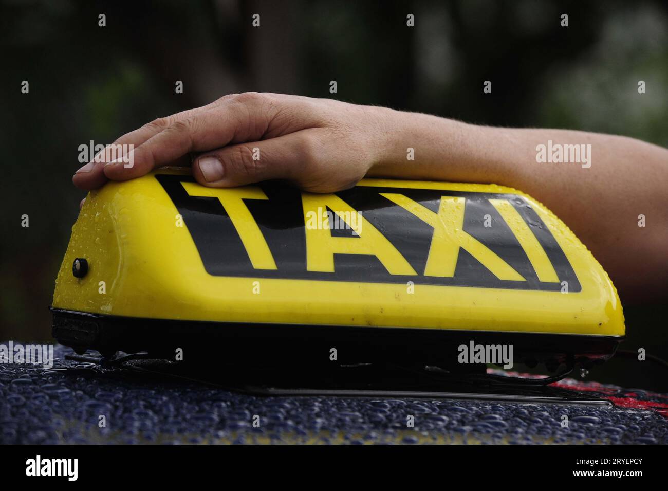 Taxi sign with arm from taxi driver Stock Photo - Alamy