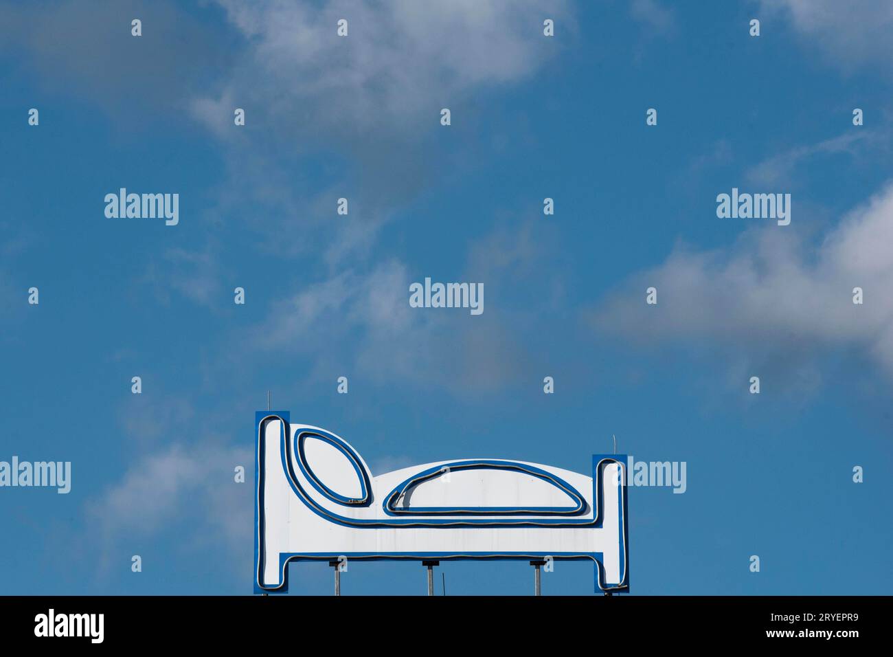 Bed symbol and blue sky Stock Photo - Alamy