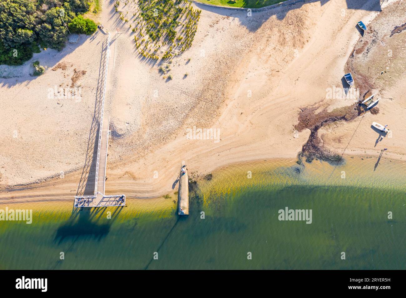 Aerial view of a T shaped jetty on the edge of a sandy beach at Barwon ...