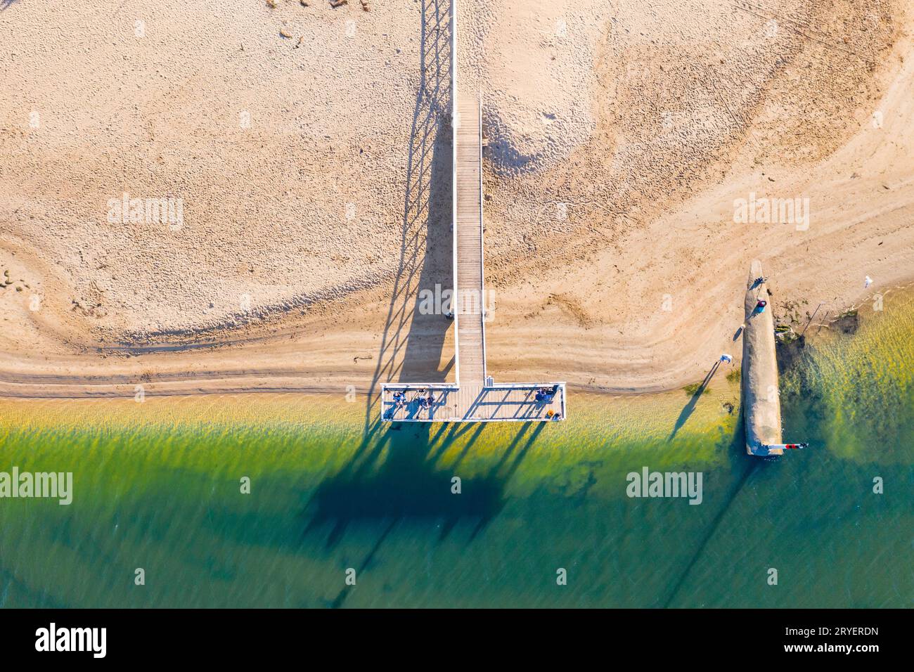 Aerial view of a T shaped jetty on the edge of a sandy beach at Barwon ...