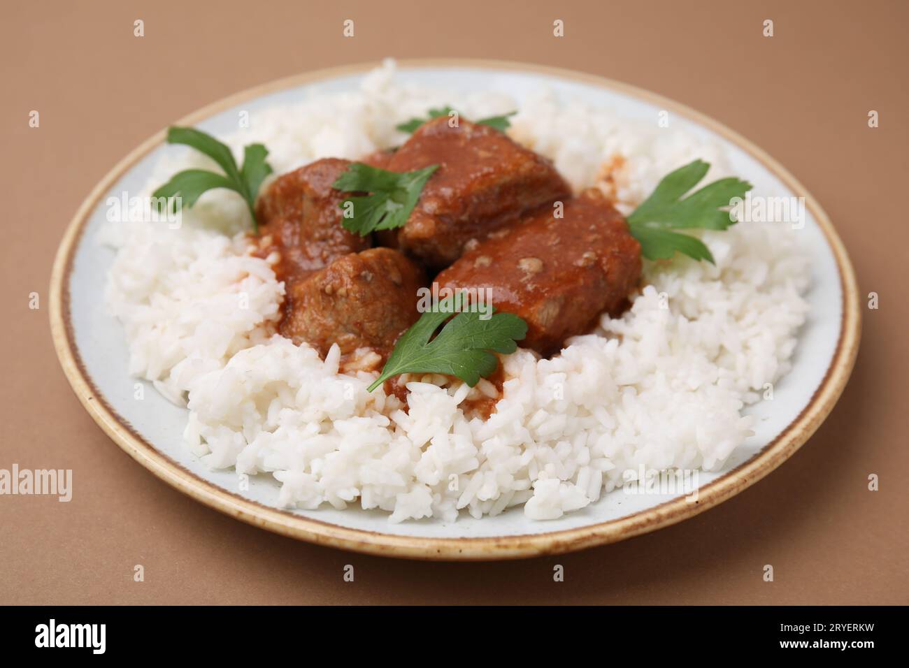 Delicious goulash with rice on brown background, closeup Stock Photo ...
