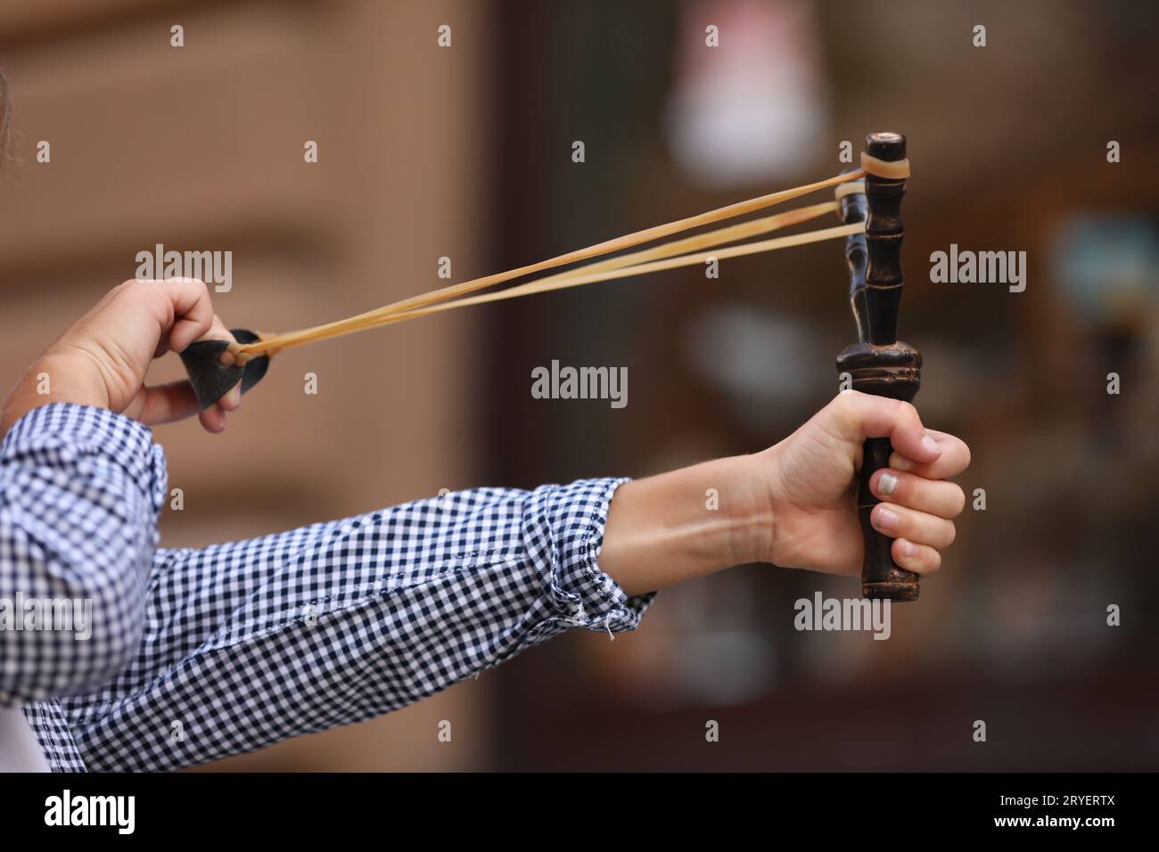 Little boy playing with slingshot outdoors, closeup Stock Photo - Alamy