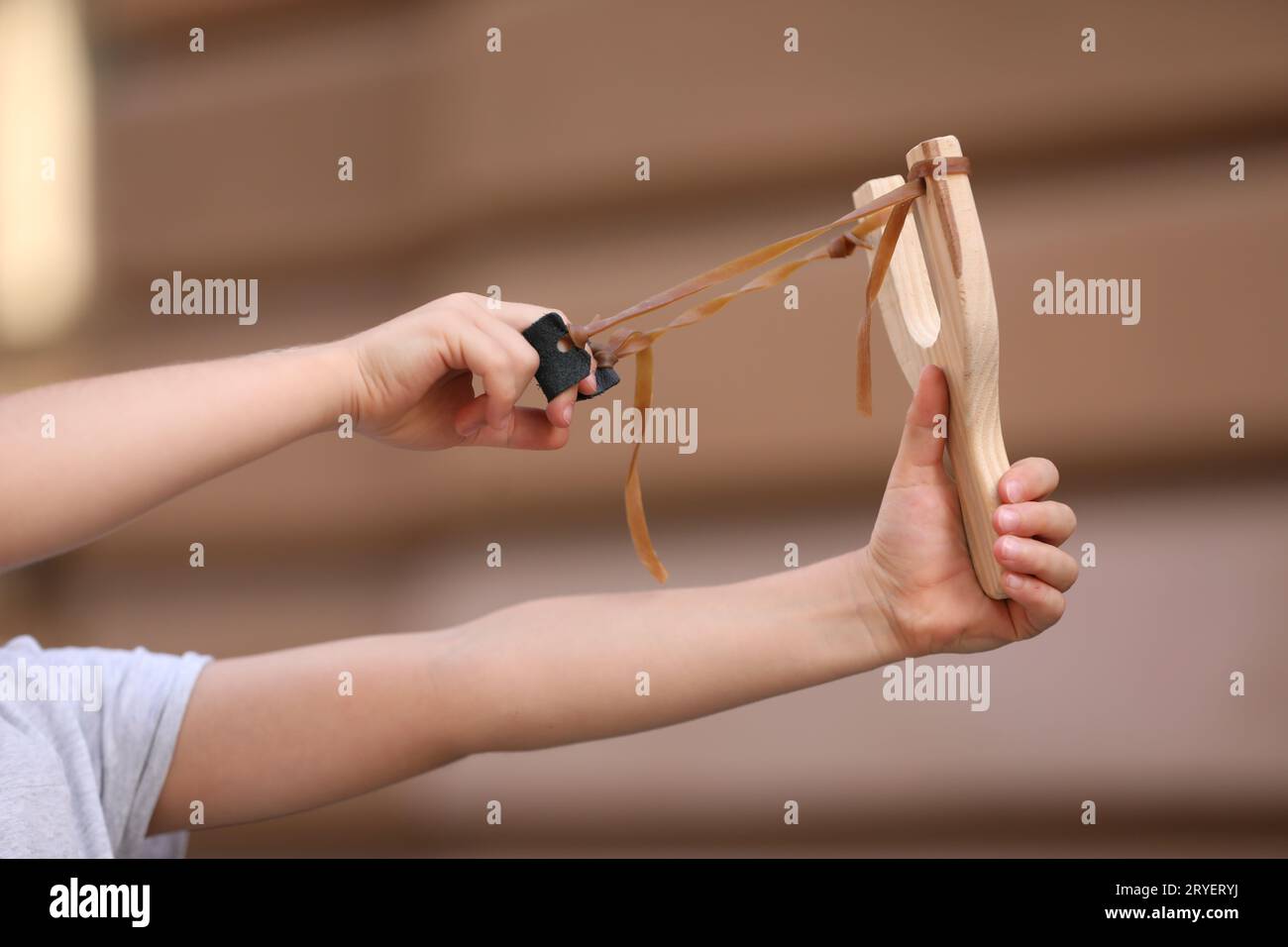 Little girl playing with slingshot outdoors, closeup Stock Photo - Alamy