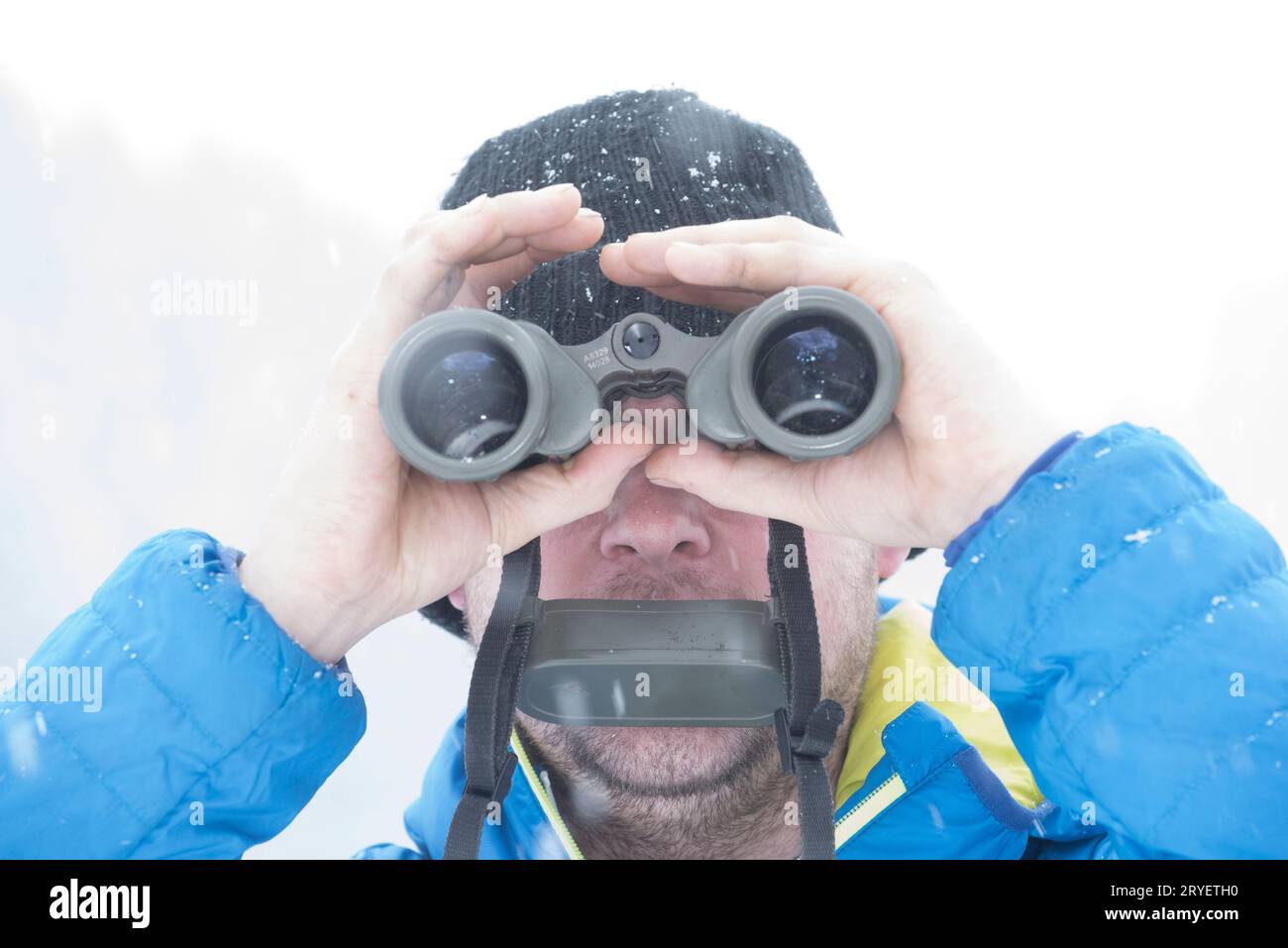 A person looking through binoculars Stock Photo - Alamy