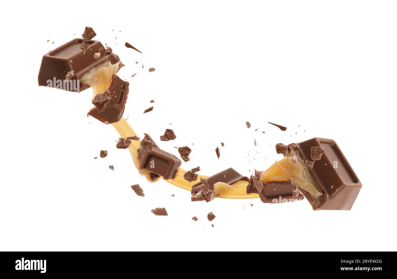 Broken chocolate bar with yummy caramel in air on white background ...