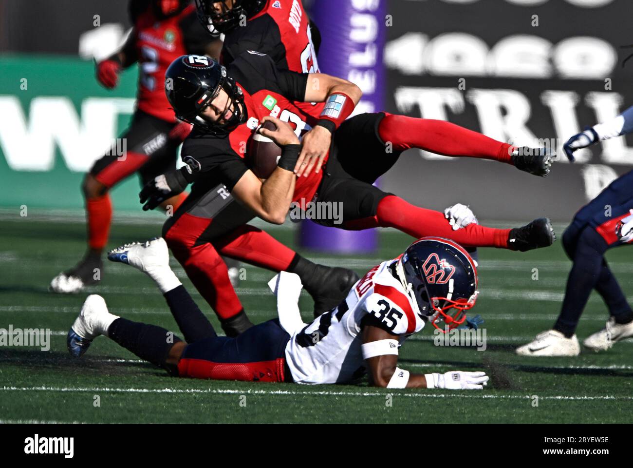 Ottawa Redblacks quarterback Dustin Crum (18) is tackled by Montreal ...