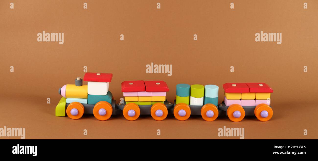 Wooden painted toy train over brown paper Stock Photo - Alamy