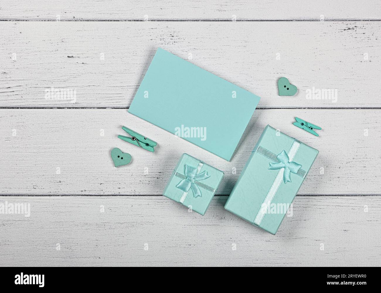 Teal gift boxes and paper note on white table Stock Photo - Alamy