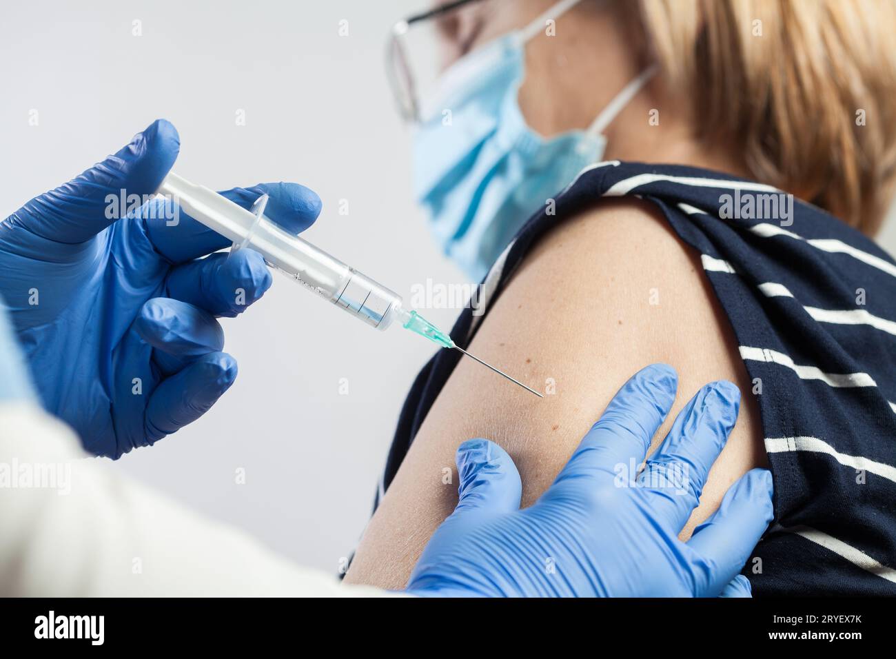 Elderly female patient wearing protective face mask,receiving COVID-19 ...