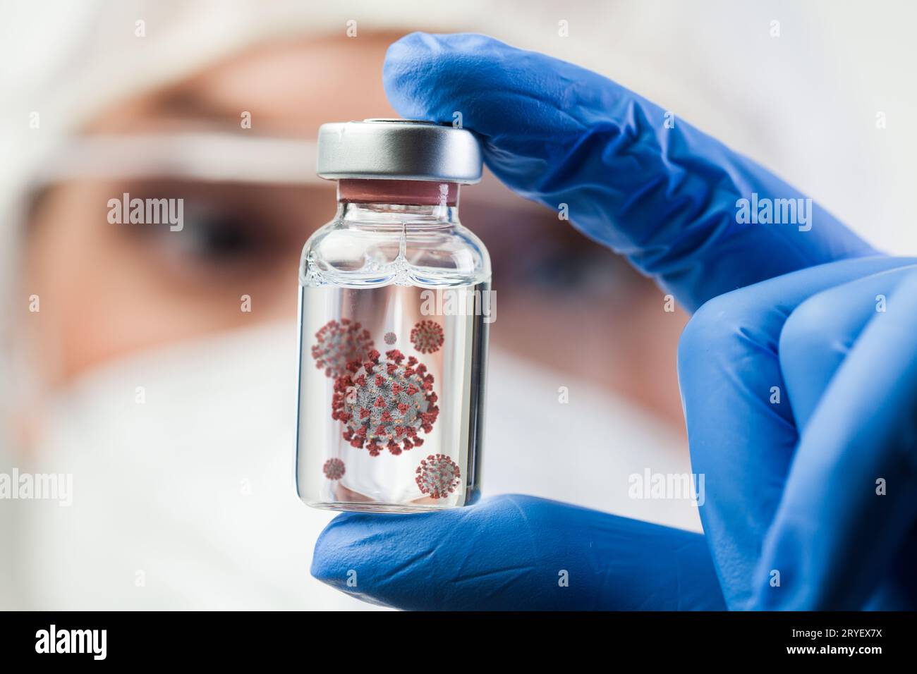 Female UK lab scientist doctor holding glass ampoule vial containing ...