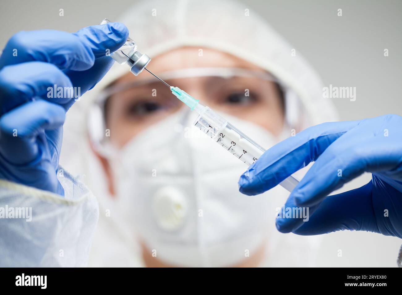 Female doctor or lab scientist holding syringe,filling injection with ...