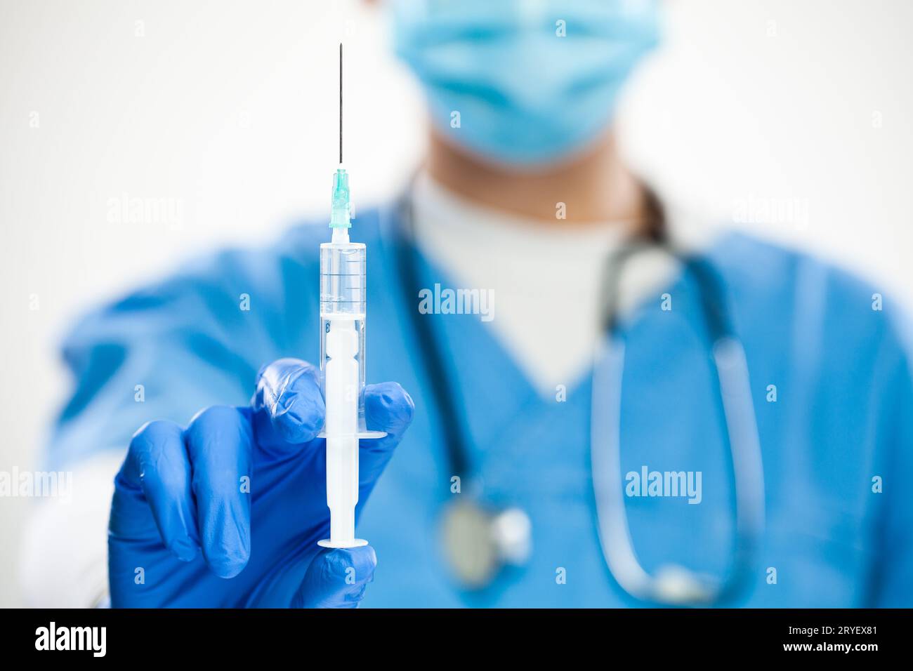 Female UK NHS doctor holding vaccine syringe with needle Stock Photo ...