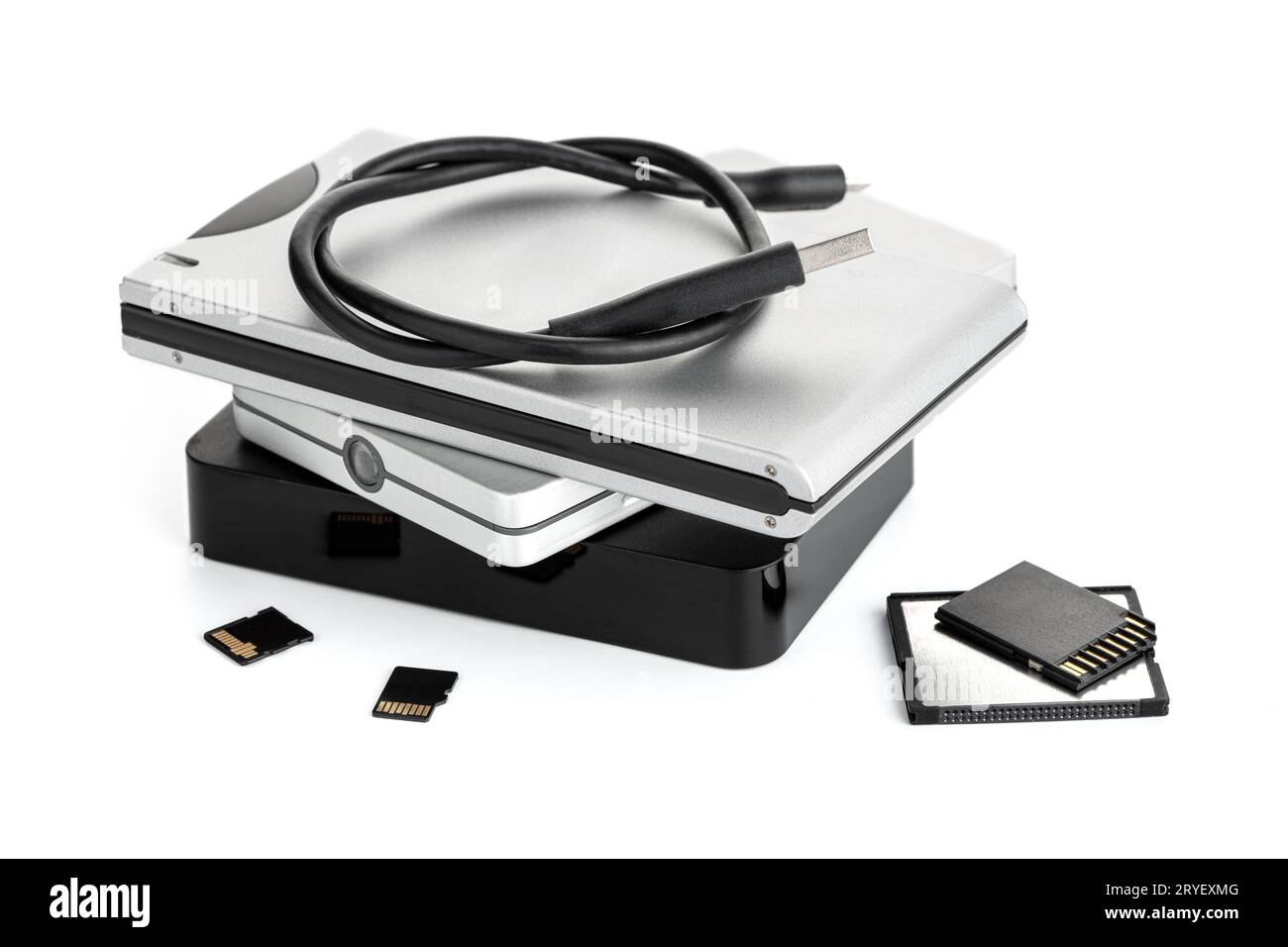 Group of external Hard disks and memory cards on white table. Data ...