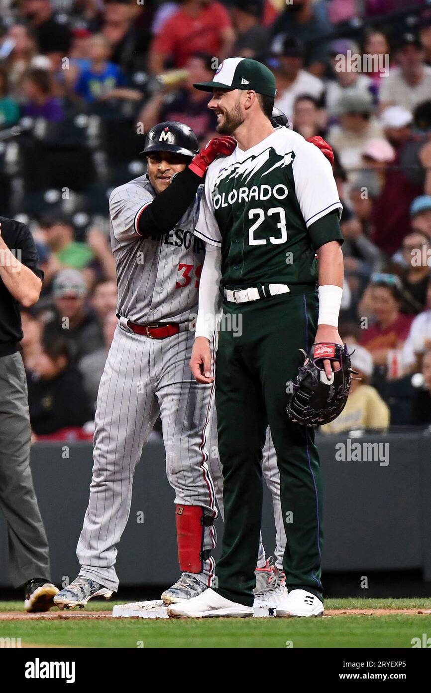 Minnesota Twins' Donovan Solano grabs the shoulders of Colorado Rockies ...