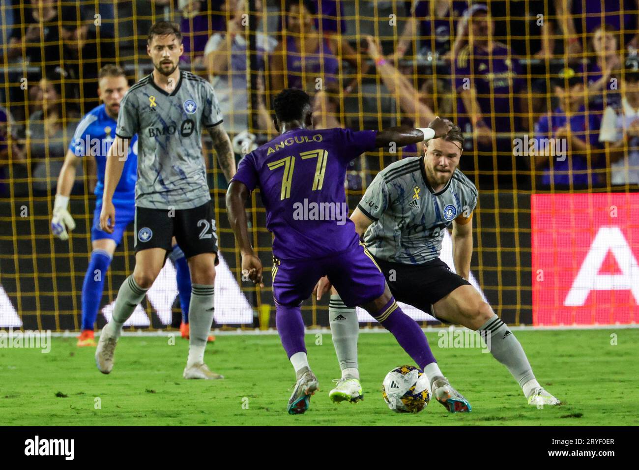 Orlando City forward Ivan Angulo , center, brings ball downfield as CF ...