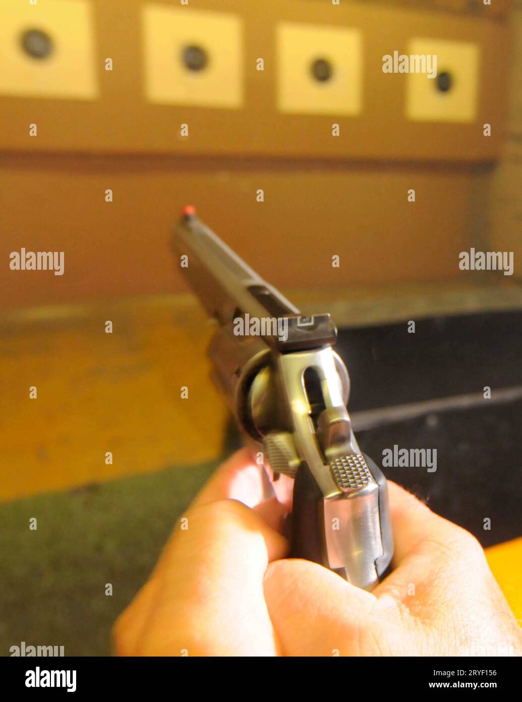 Sport shooter firing at target Stock Photo - Alamy