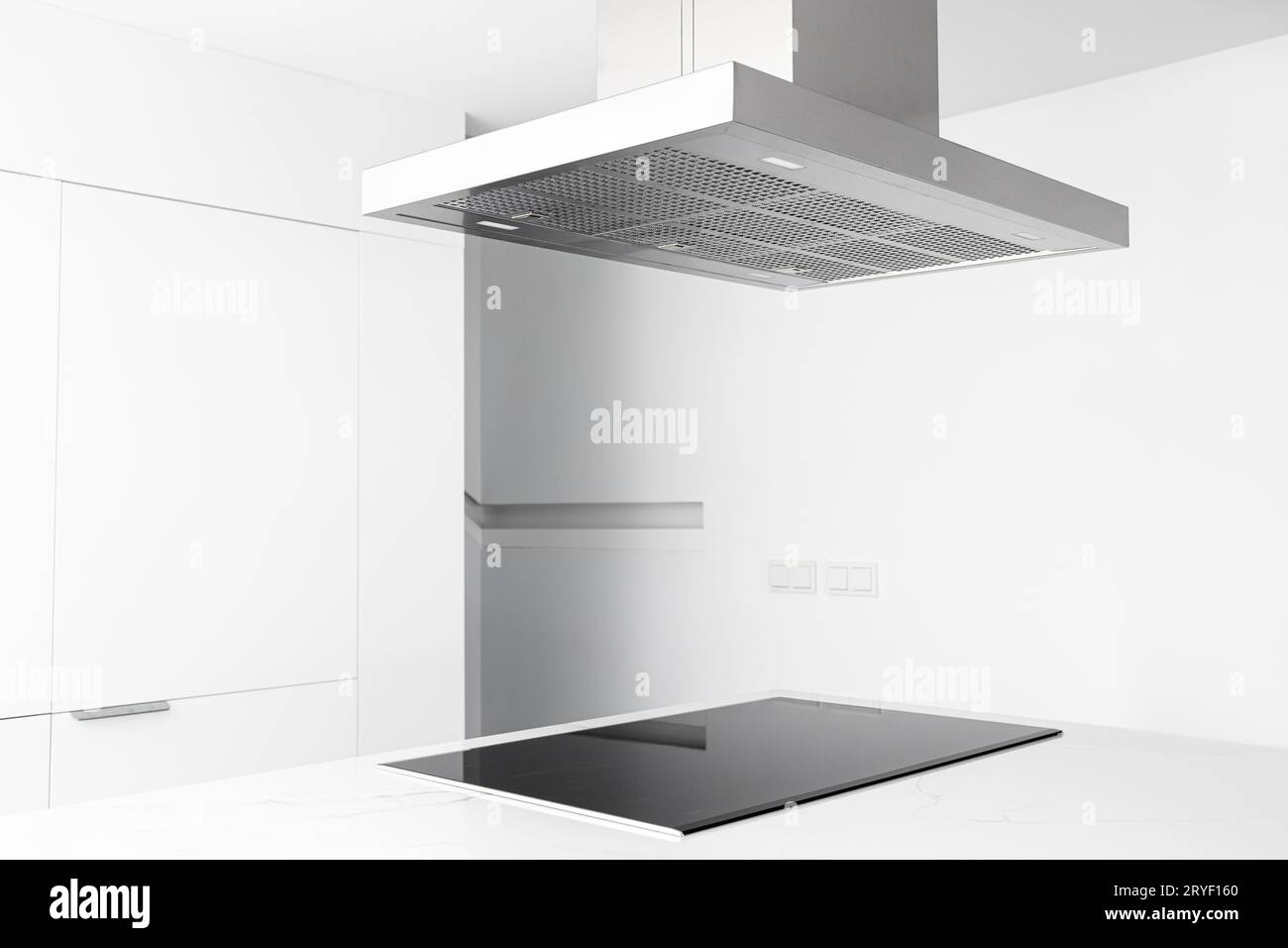 View of a cooker hood and electric stove of a modern and minimalist ...