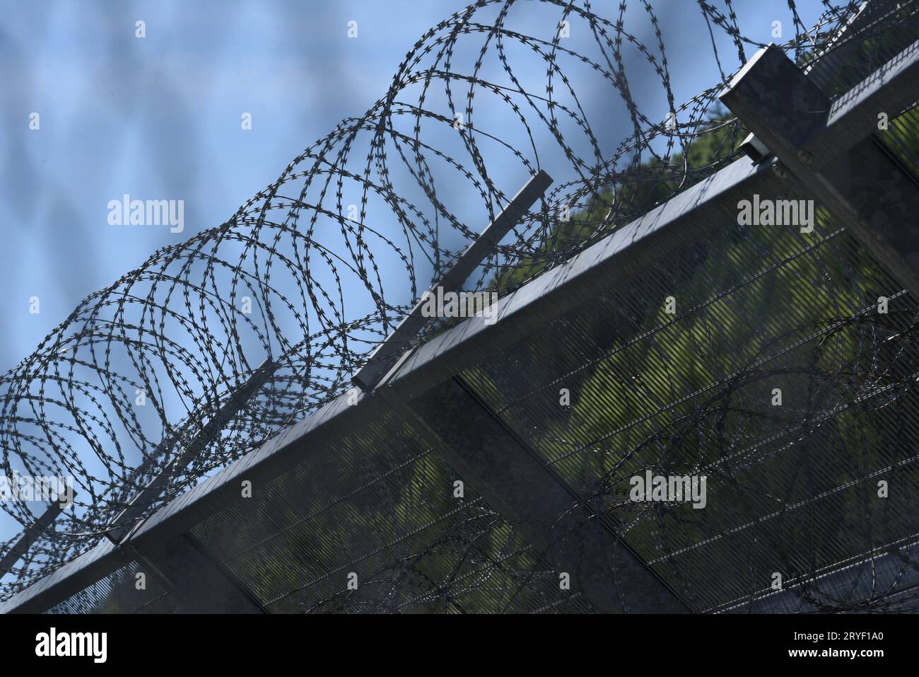 Barbed wire fence as security measurement in prison Stock Photo - Alamy