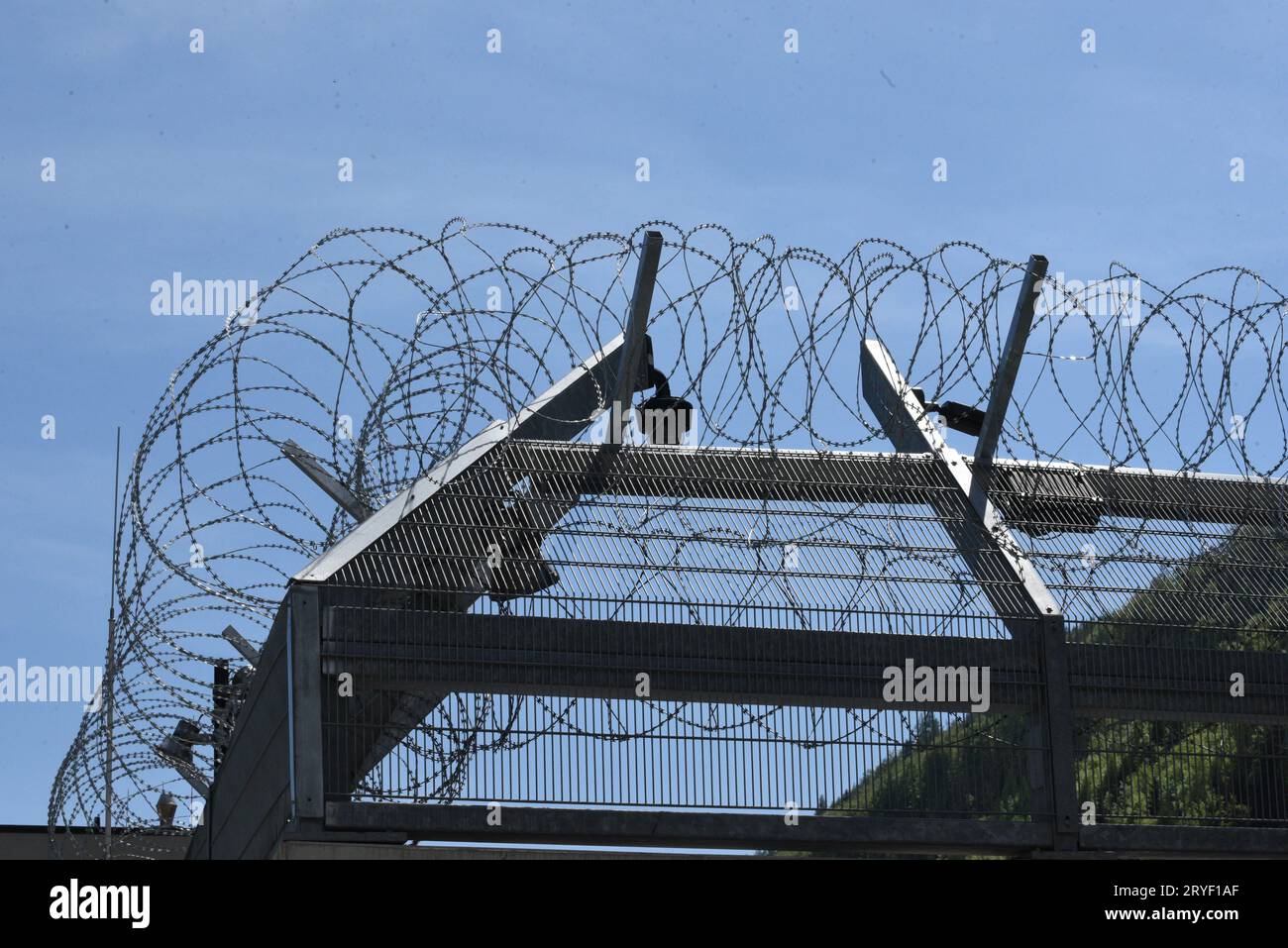 Barbed wire fence as security measurement in prison Stock Photo - Alamy