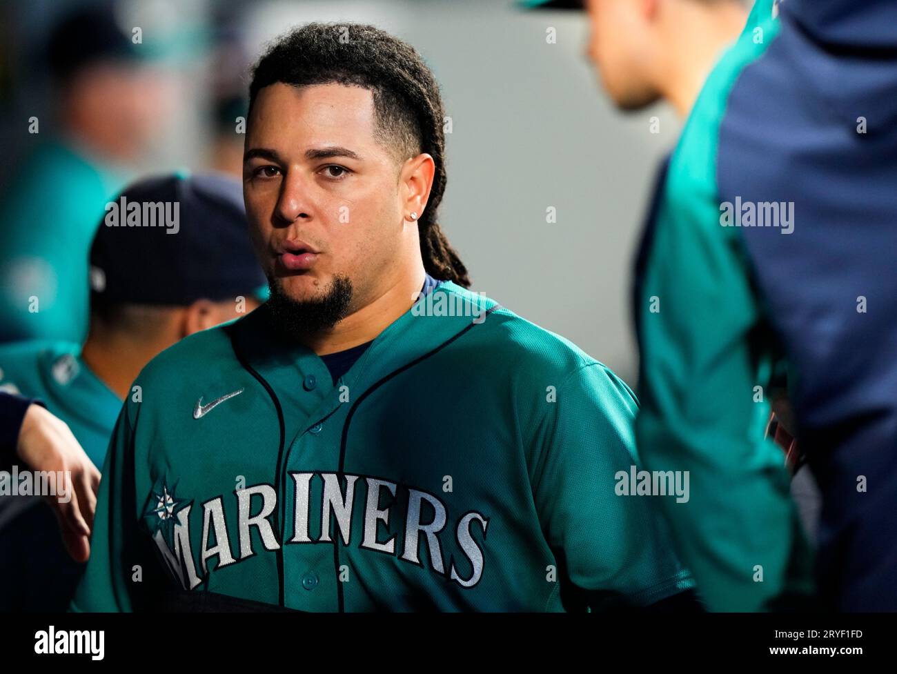 Seattle Mariners starting pitcher Luis Castillo walks in the dugout ...