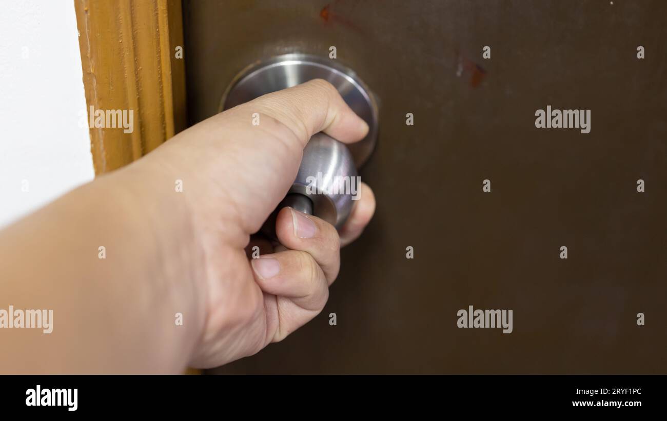 Man hand open door knob or opening the door Stock Photo - Alamy