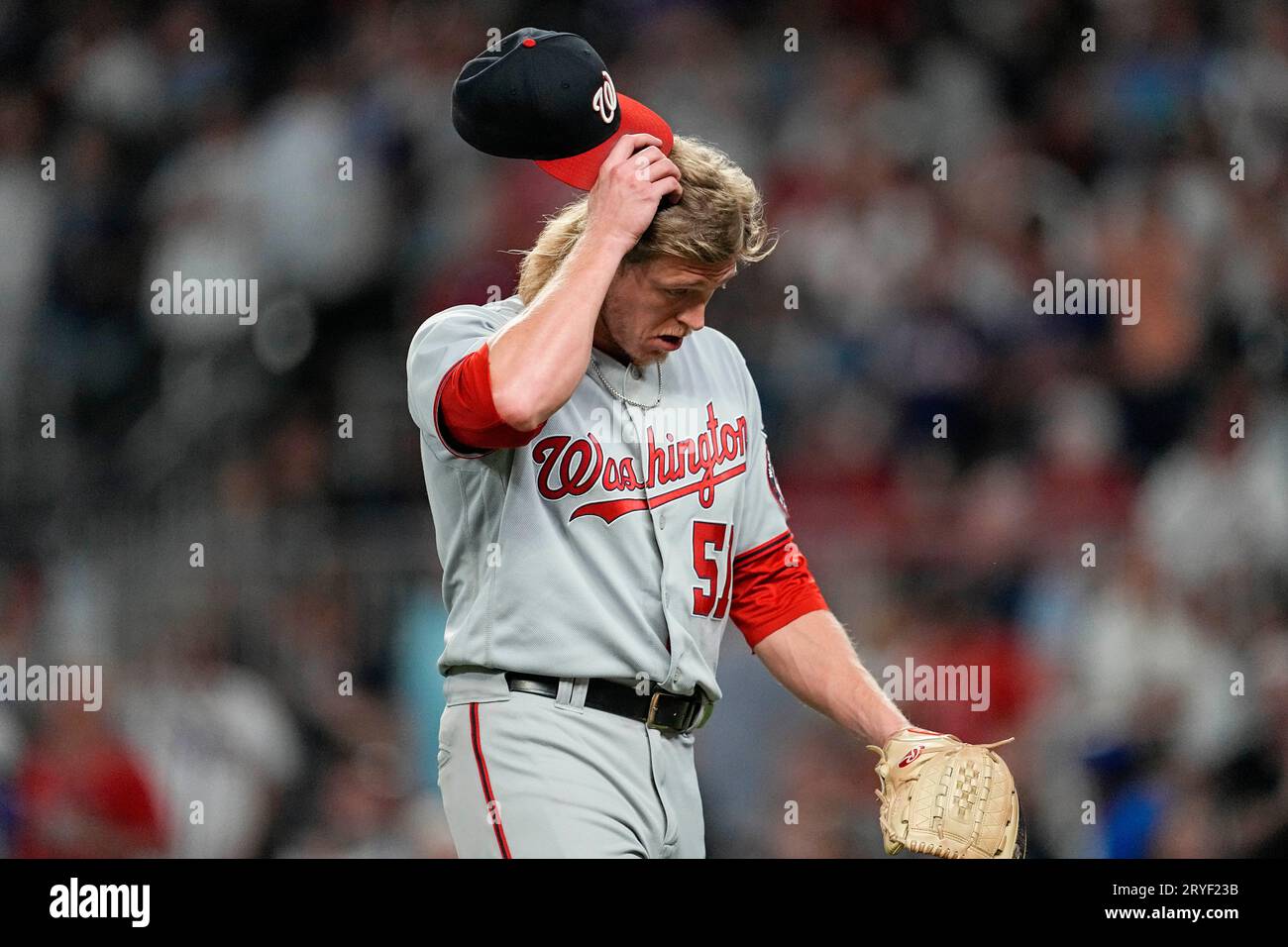 Washington Nationals relief pitcher Jordan Weems scratches his head ...