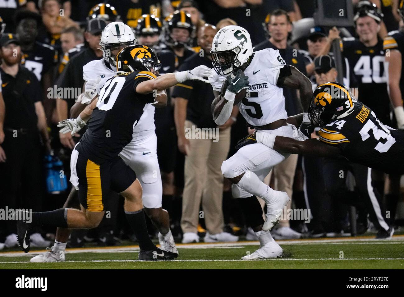 Michigan State running back Nathan Carter (5) runs between Iowa ...