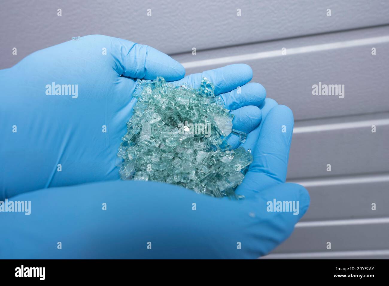 Person holding glass splinters in their hands Stock Photo - Alamy