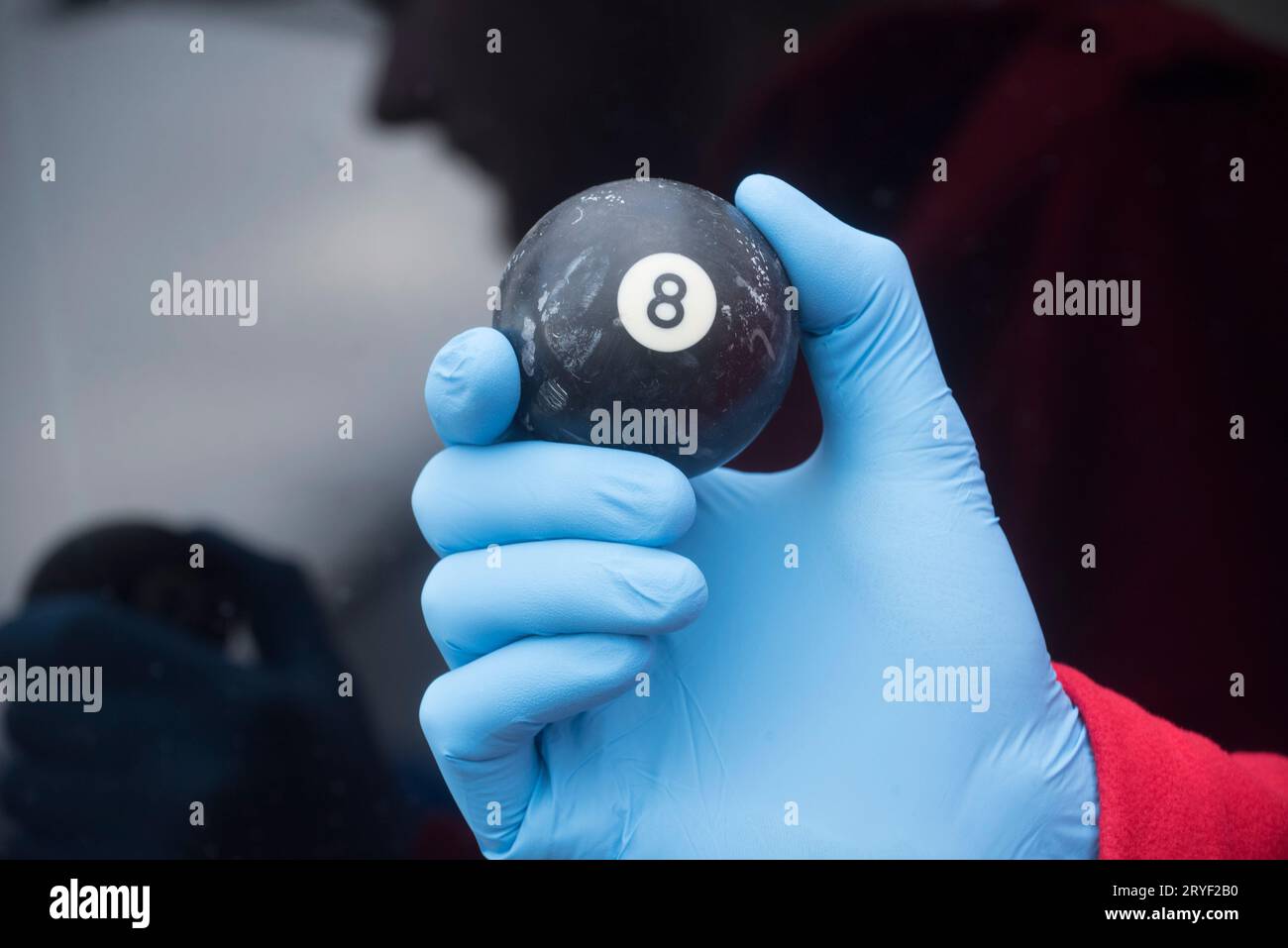 Person holding the black number eight ball in their hand Stock Photo ...