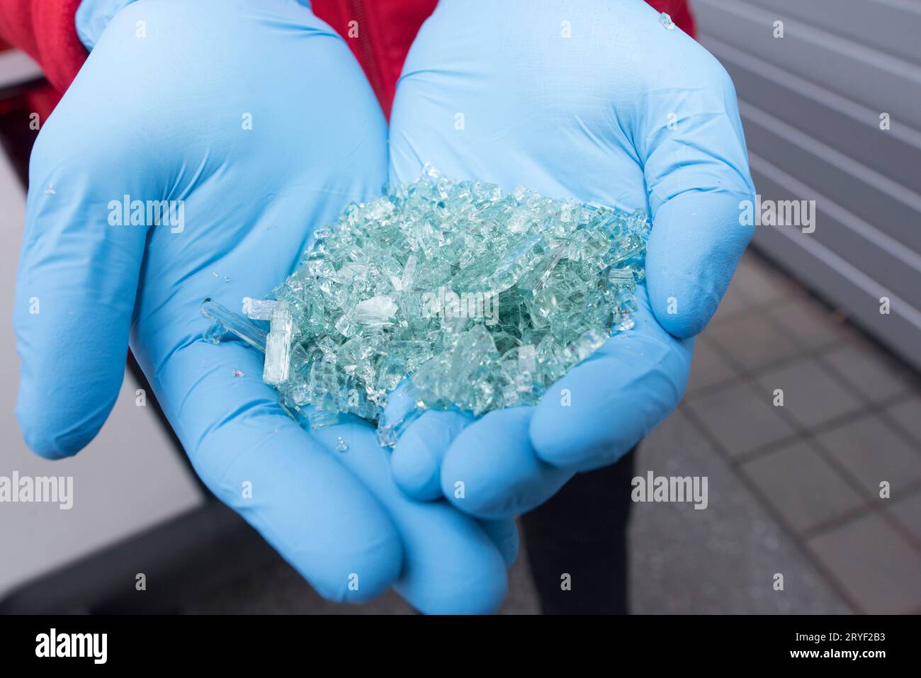 Person holding glass splinters in their hands Stock Photo - Alamy